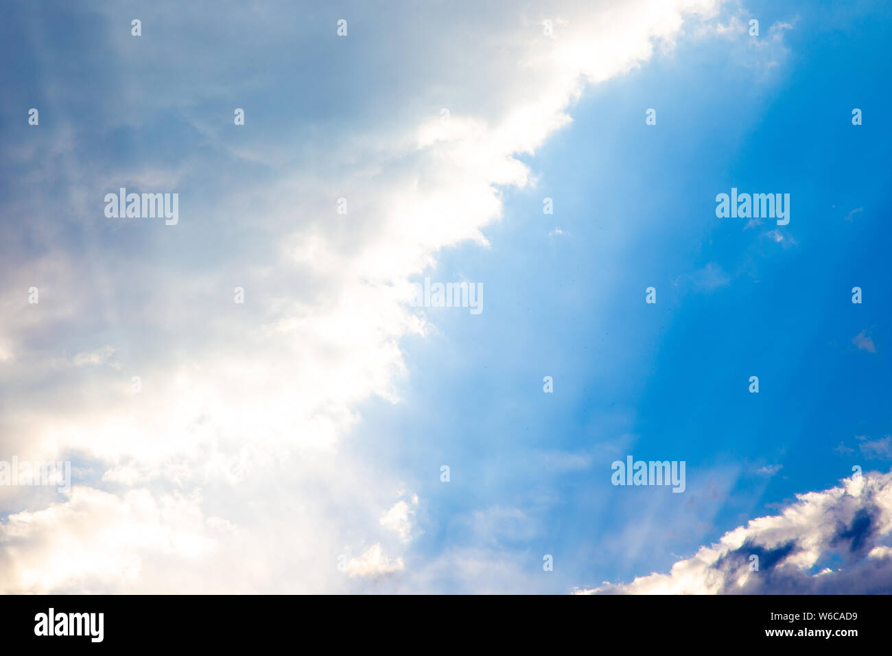 blue sky with clouds backlit by the soft rays of the sun Stock Photo ...