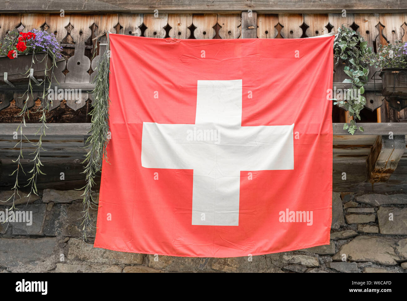Swiss flag hanging on facade of traditional build swiss house Stock ...