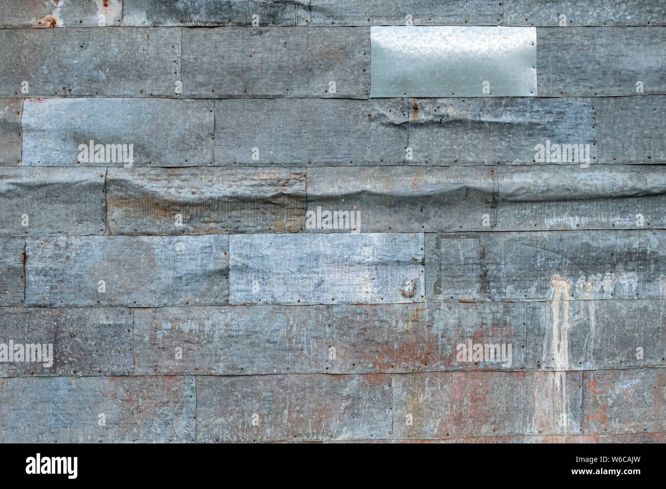 Metal pattern background. Diverse metall sheets nailed on a wall Stock ...