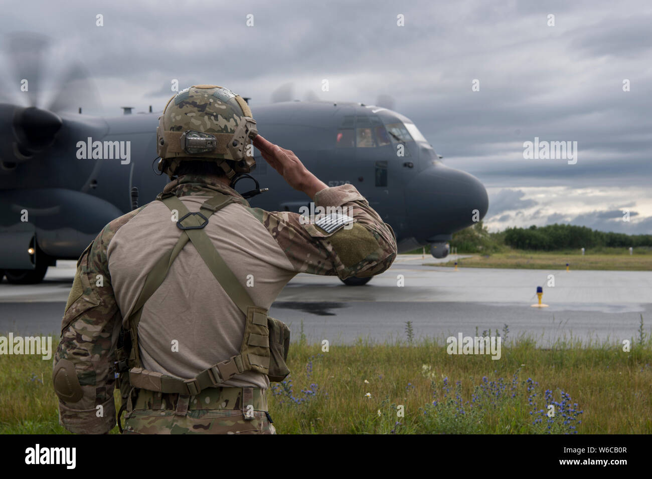 A U.S. Air Force Special Tactics Operator salutes the pilot of an MC ...