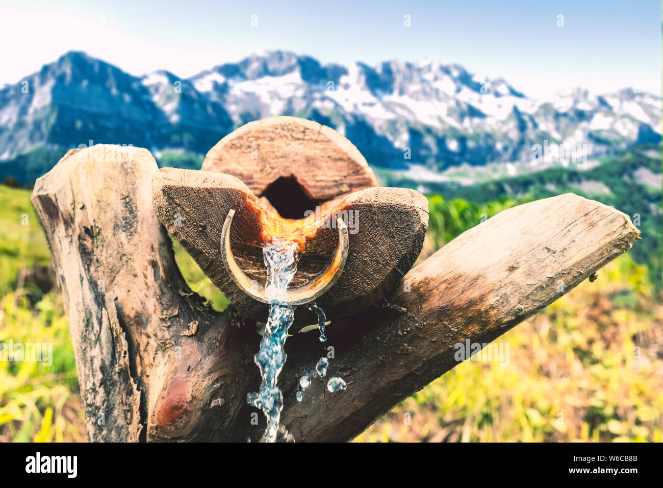 Fresh water source trickling water with mountain range background Stock ...