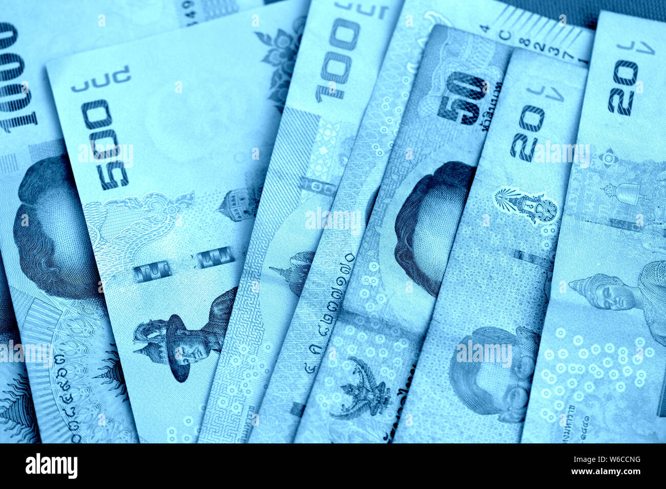 Various banknotes thai baht close up. Money background blue color toned ...