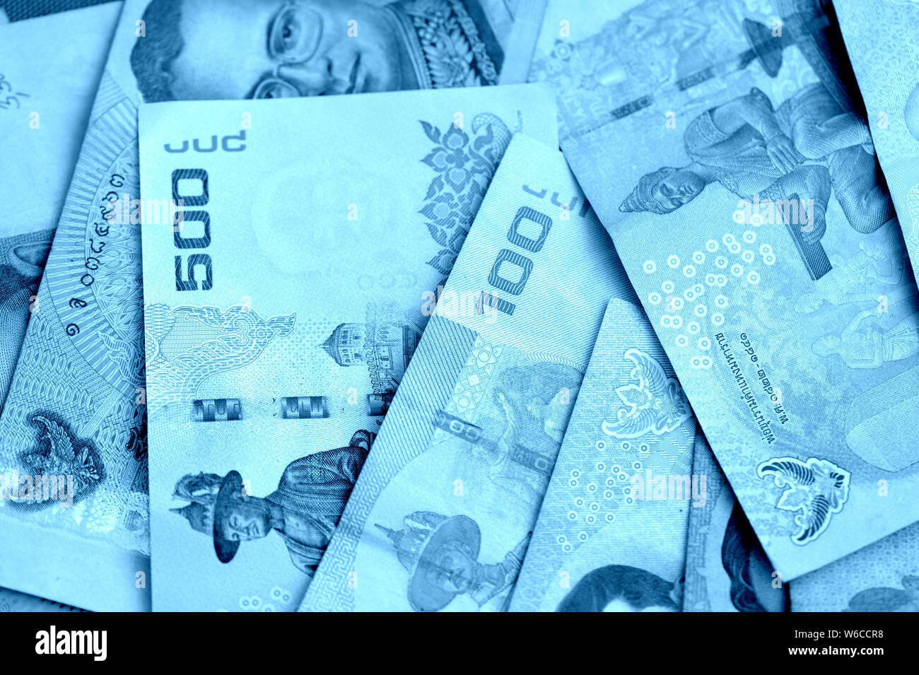 Various banknotes thai baht close up. Money background blue color toned ...