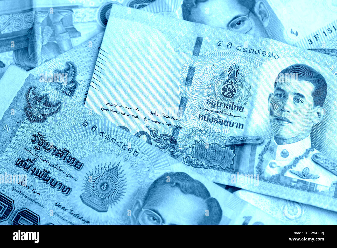 Various banknotes thai baht close up. Money background blue color toned ...