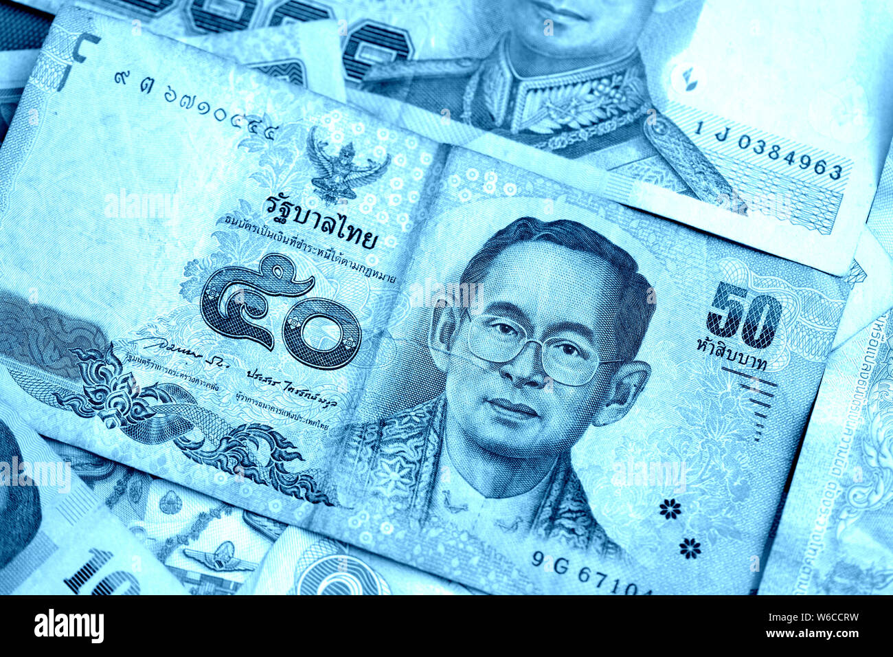 Various banknotes thai baht close up. Money background blue color toned ...