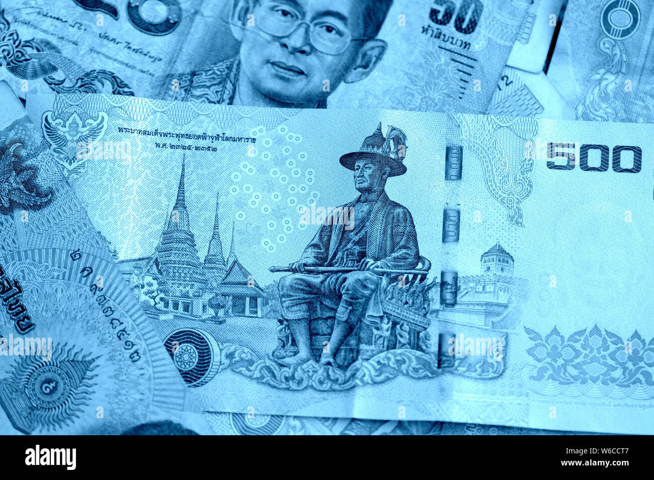 Various banknotes thai baht close up. Money background blue color toned ...