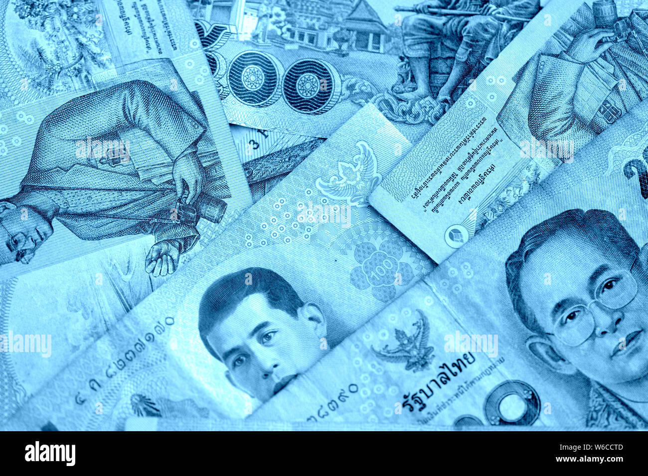 Various banknotes thai baht close up. Money background blue color toned ...
