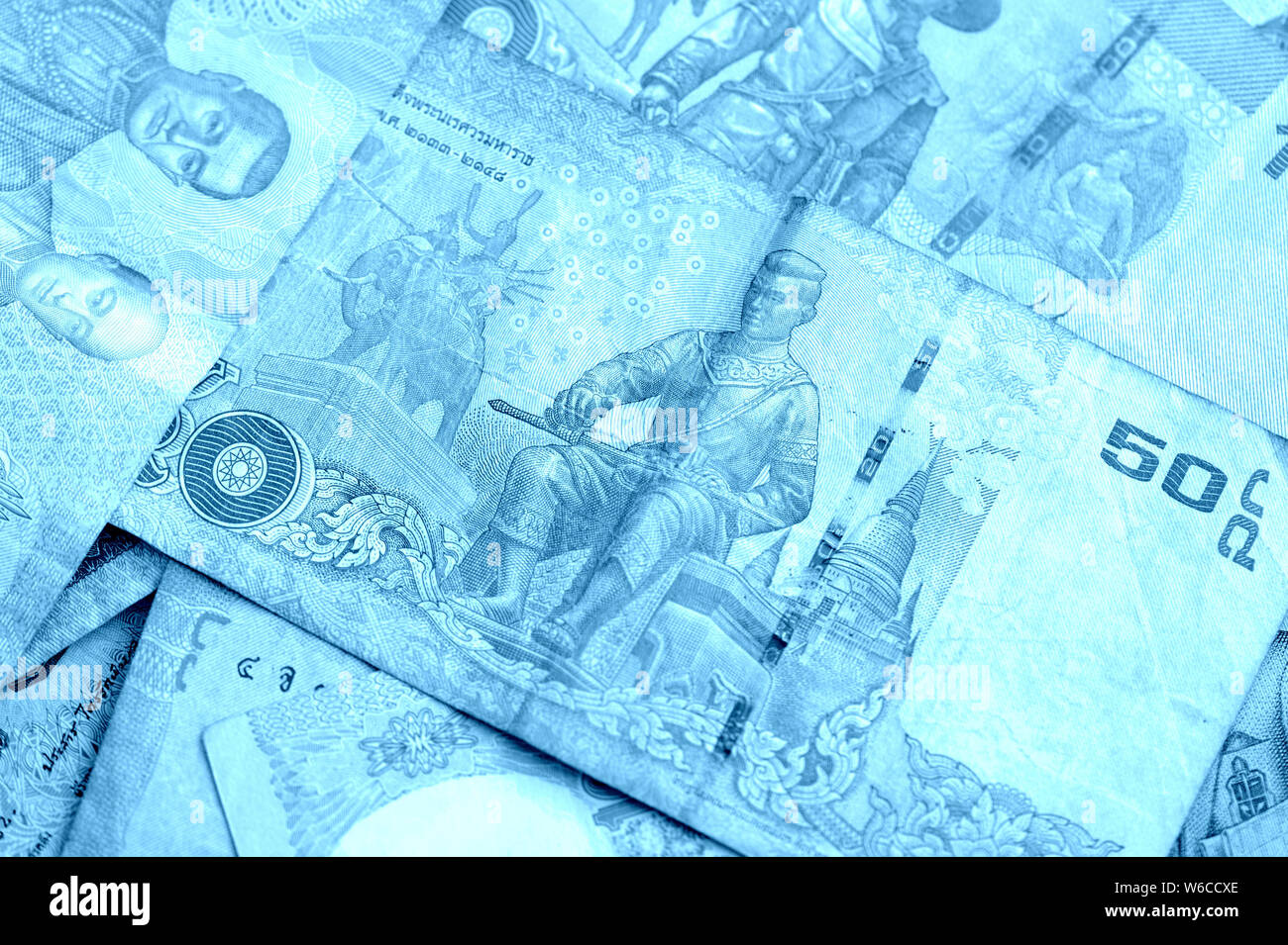 Various banknotes thai baht close up. Money background blue color toned ...