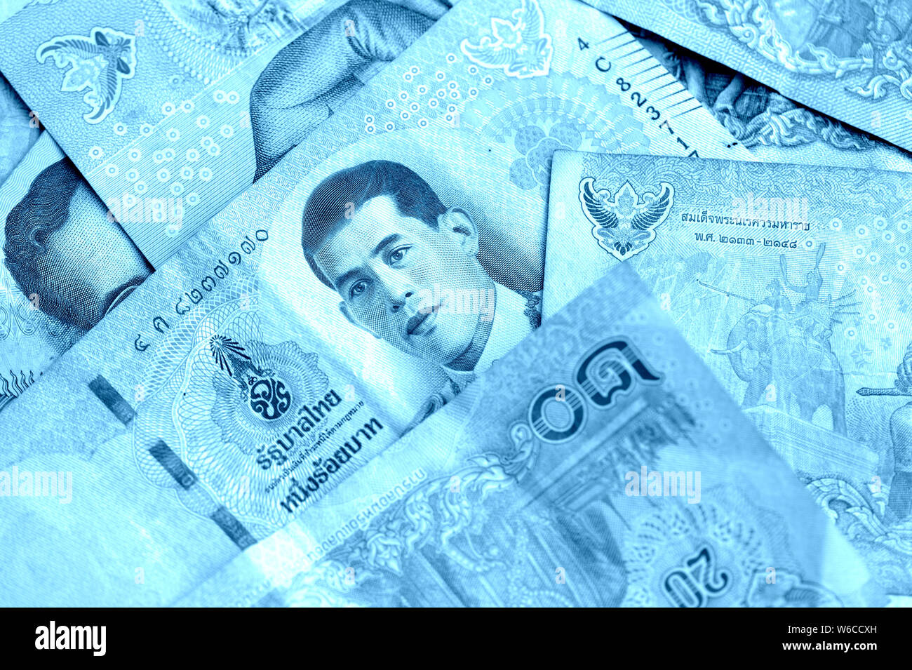 Various banknotes thai baht close up. Money background blue color toned ...