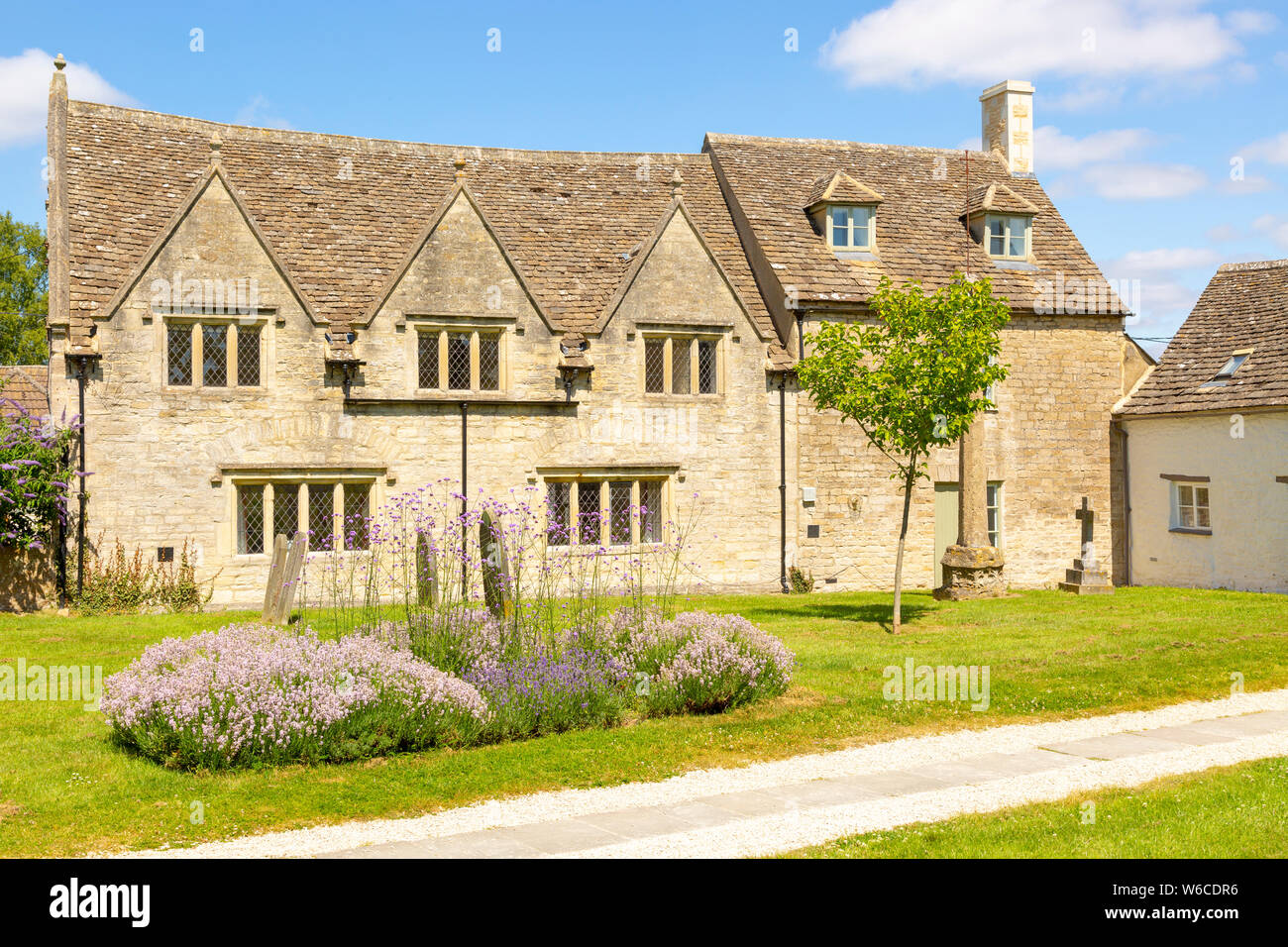 Historic stone cottages and 14th century market cross in Saxon town of ...