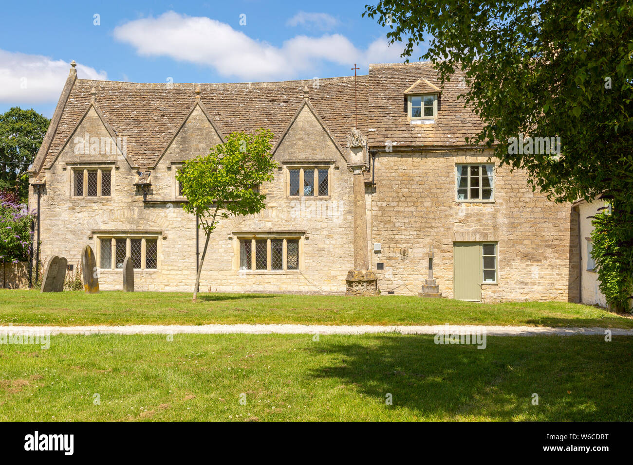 Historic stone cottages and 14th century market cross in Saxon town of ...