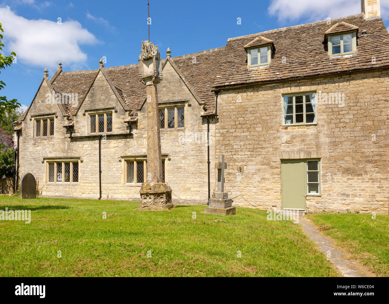 Historic stone cottages and 14th century market cross in Saxon town of ...