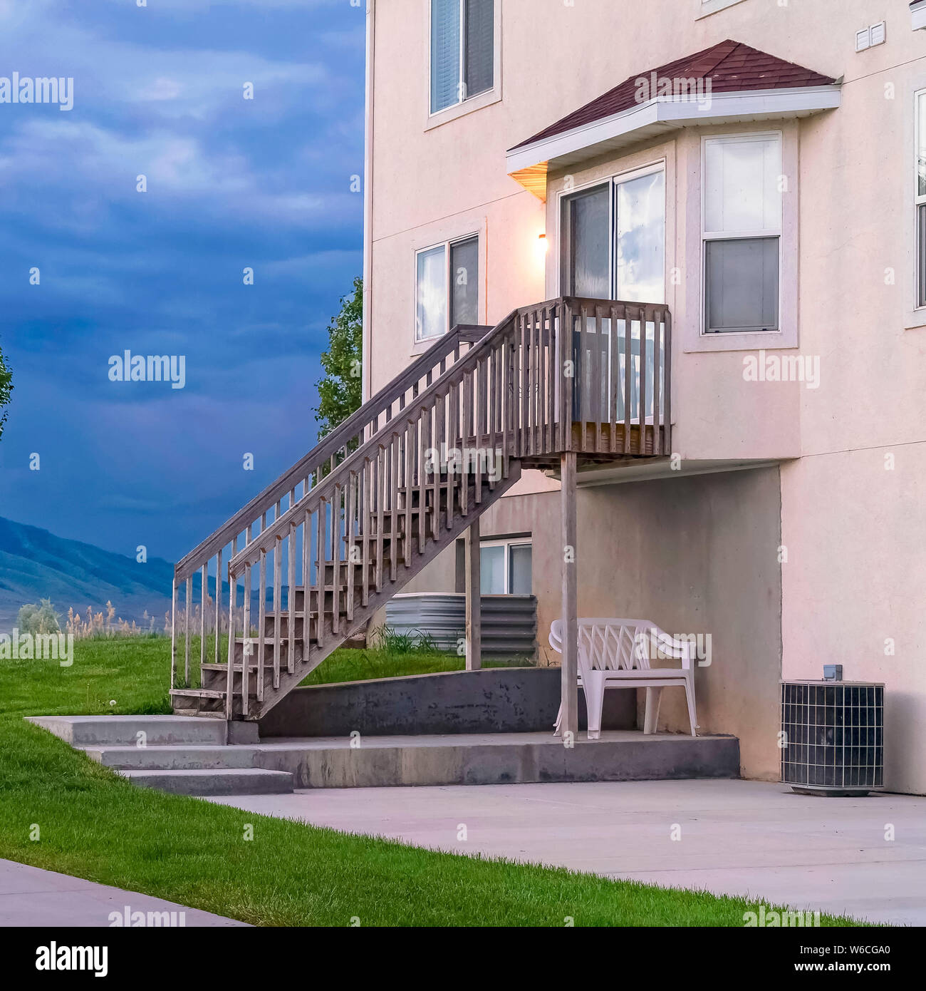 Square Pathway in front of a home with stairs leading to the second ...