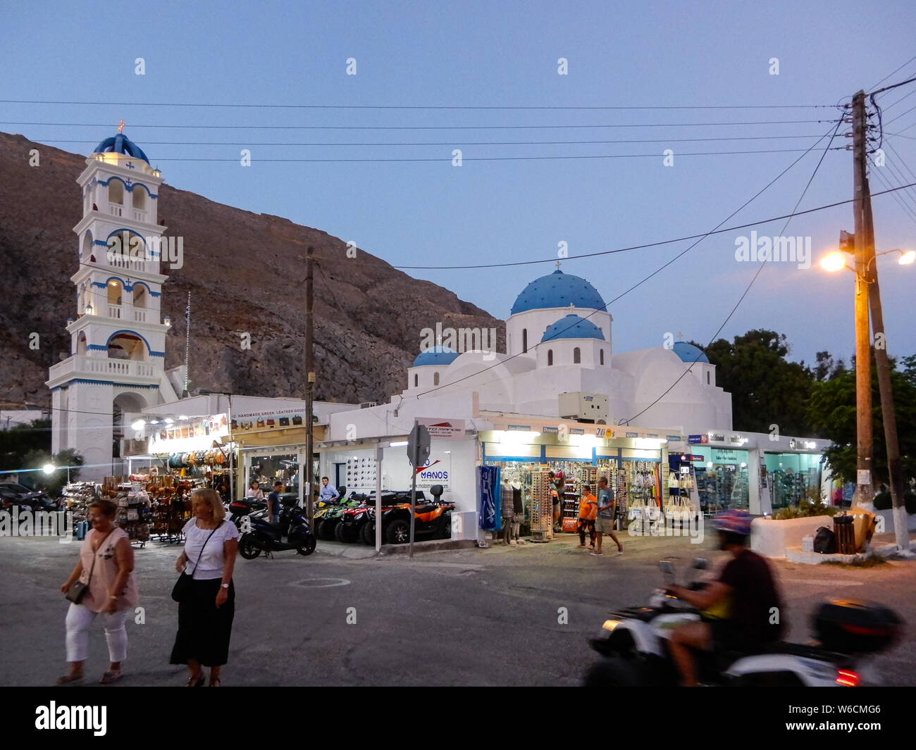 Perissa, Greece - July 13 2019: Tourists walk past the Holy Cross ...