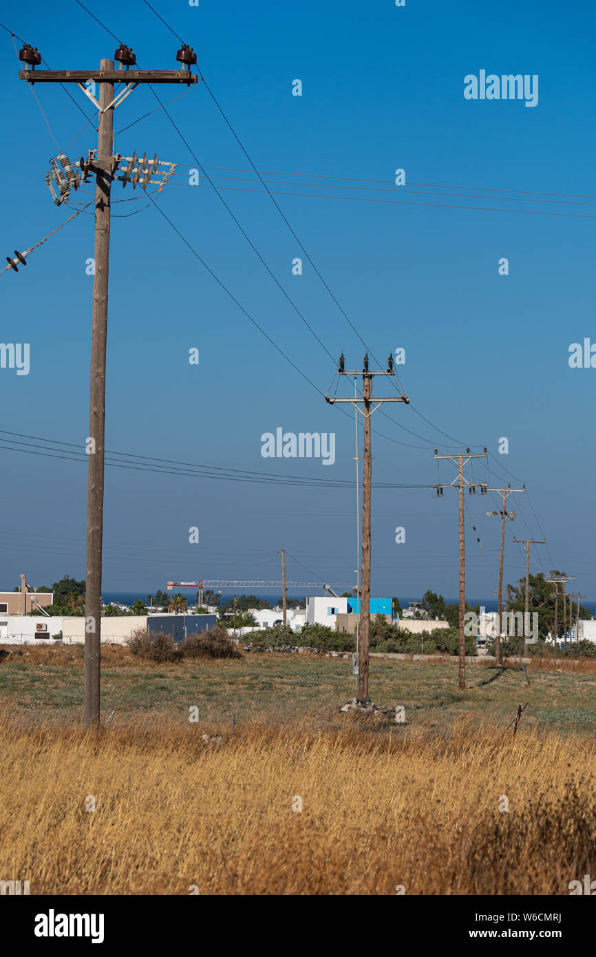 Perissa, Greece - July 20 2019: A line of Telegraph poles leading down ...