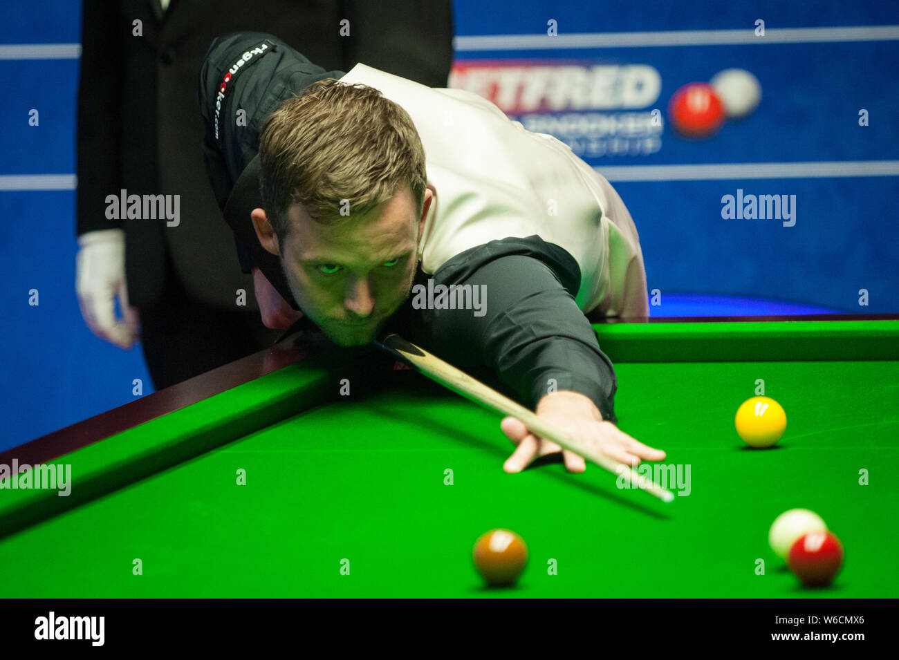 Jamie Jones of Wales plays a shot to Shaun Murphy of England in their ...