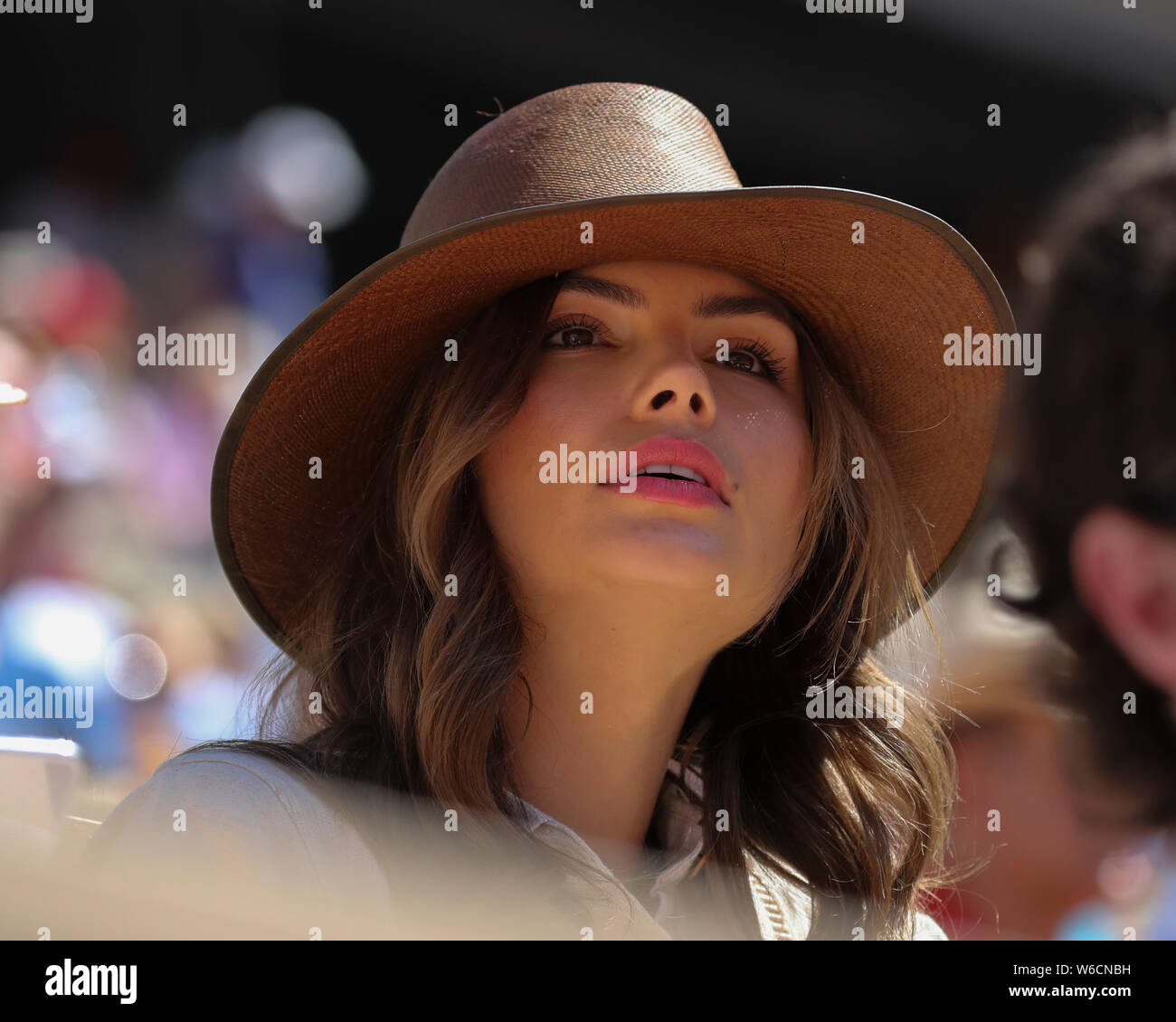 Close up of female spectator wearing a sun hat watching French Open ...