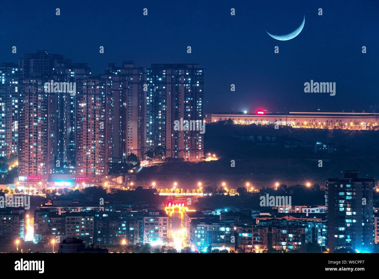 Night view of houses and high-rise buildings along the Yangtze River in ...