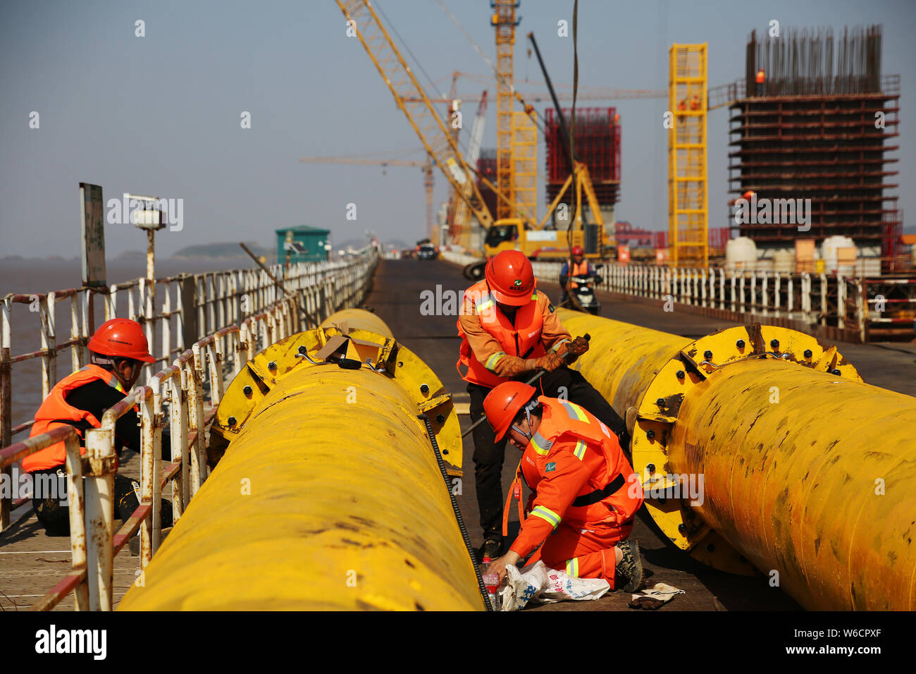 Chinese workers labor at the construction site of the Yushan Bridge, a ...