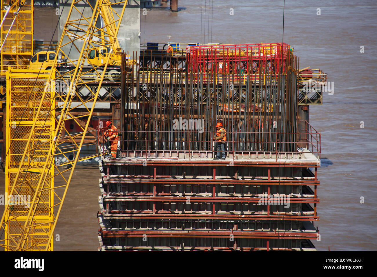 Chinese workers labor at the construction site of the Yushan Bridge, a ...