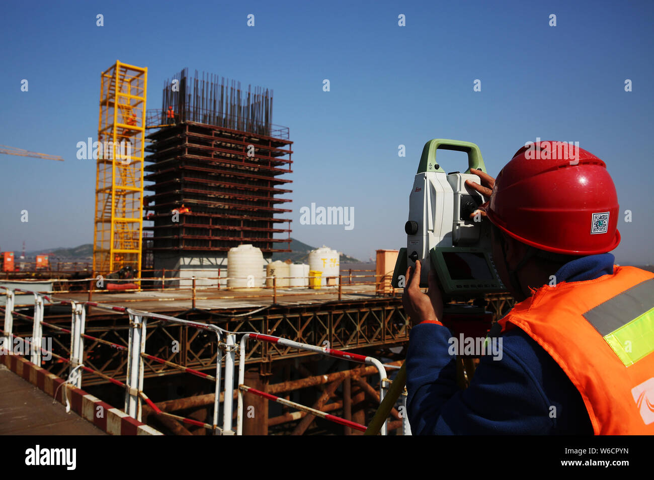 Chinese workers labor at the construction site of the Yushan Bridge, a ...