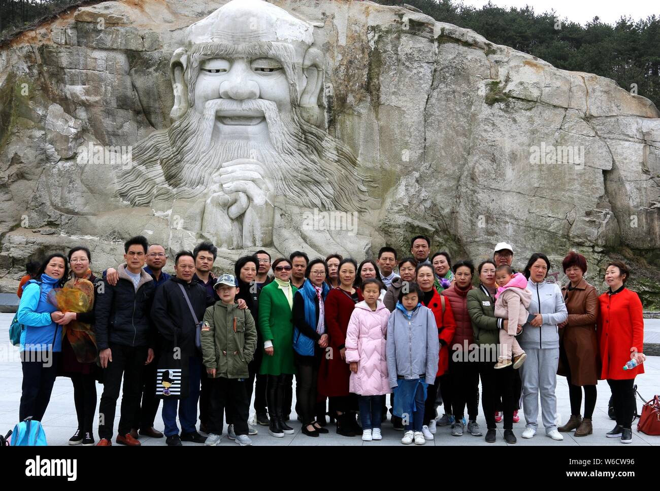 Visitors pose for photos with China's largest Laozi statue in a scenic ...