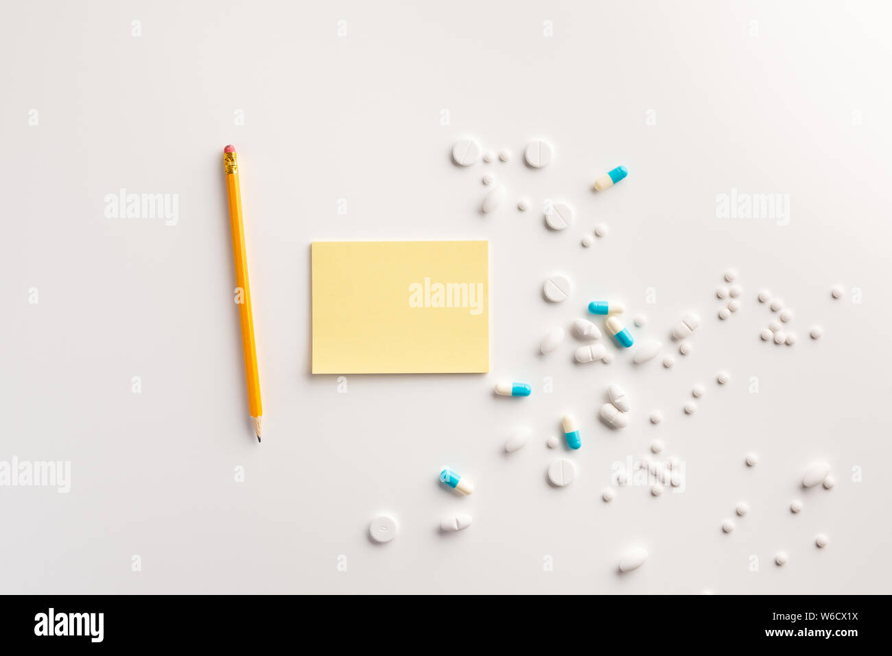 Notepad, pencil and pills on white background. Medical concept. Flat ...