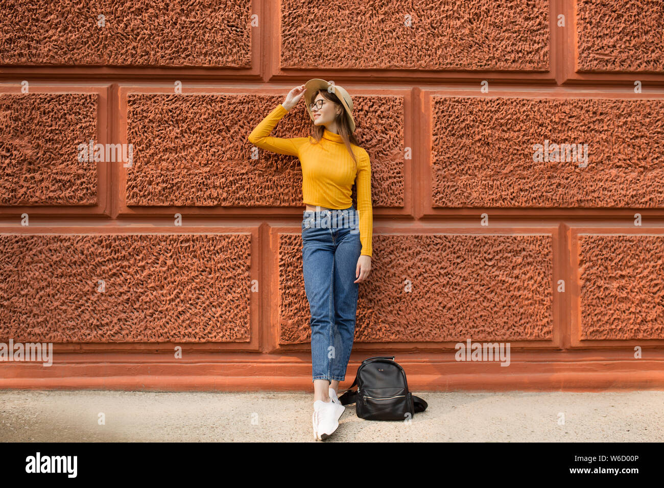 Attractive girl standing near wall hi-res stock photography and images ...