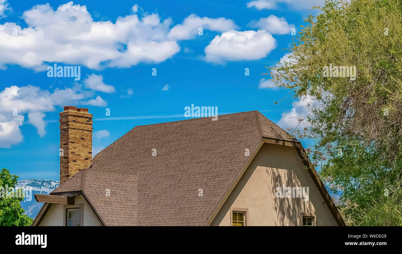 Panorama frame Exterior of a home with brick wall dark roof shiny ...