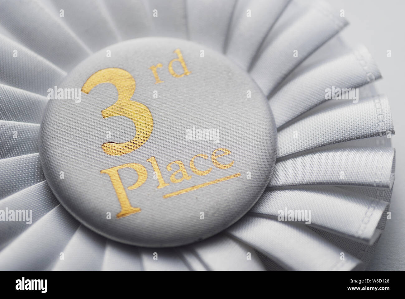 Closeup champion 3rd place ribbon with gold text on white background ...