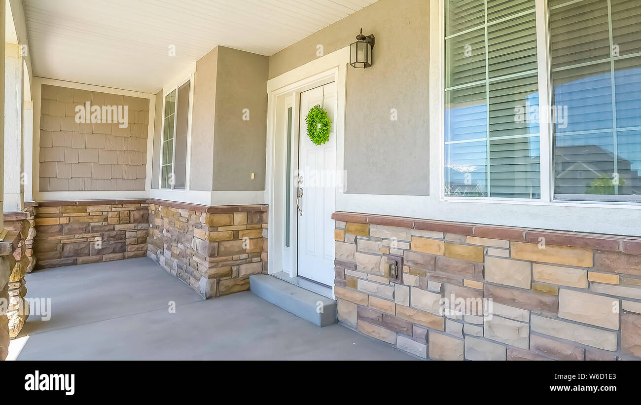 Panorama frame Porch of a home with a combination of concrete and stone ...