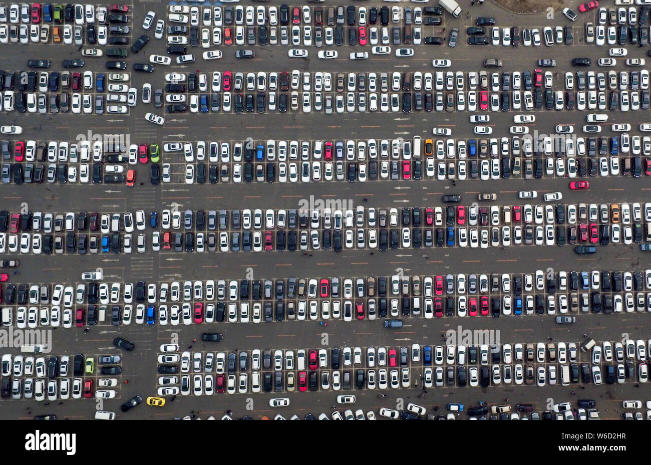 Aerial view of masses of vehicles at a parking lot of a shopping mall ...
