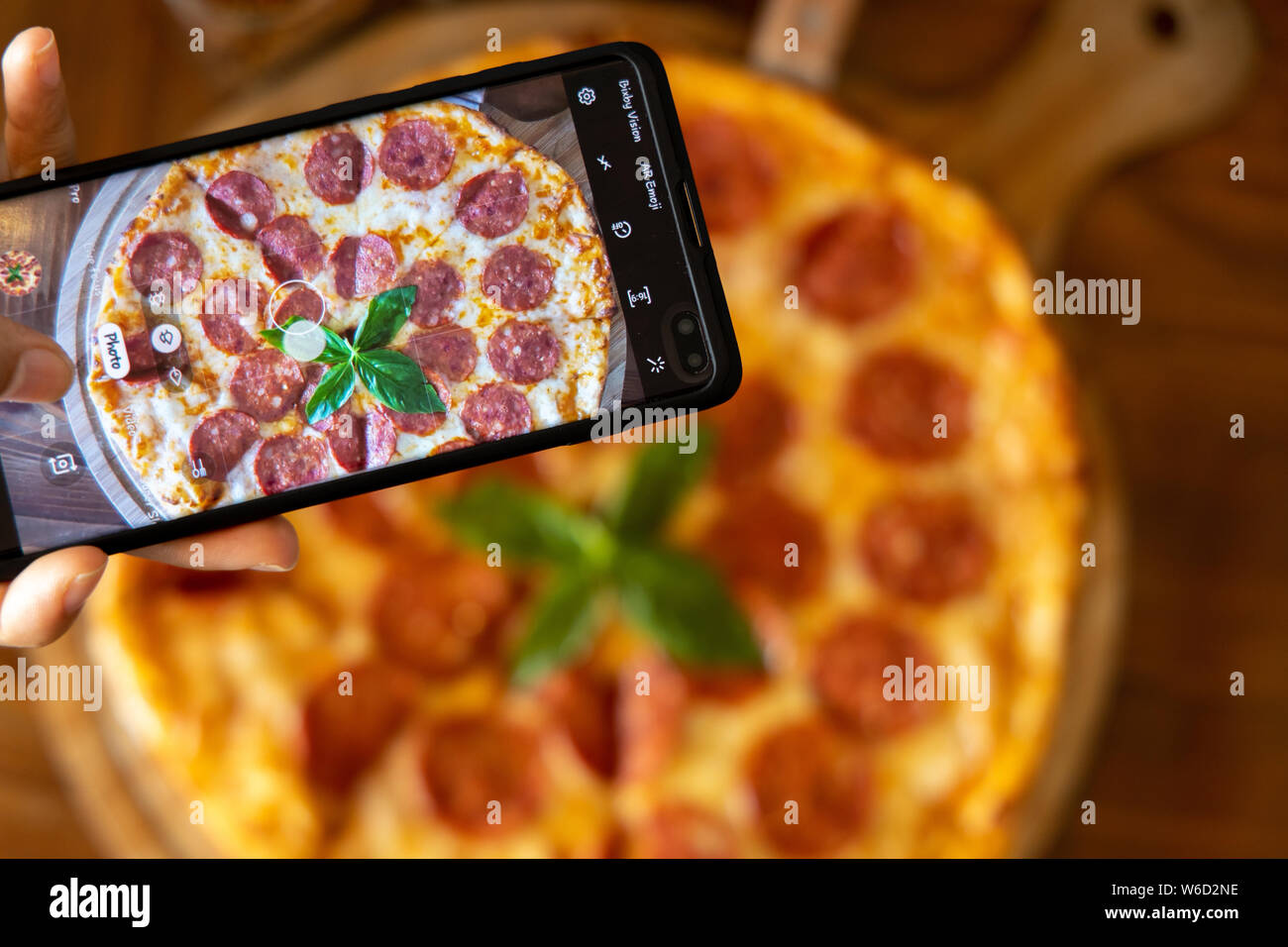 Pepperoni pizza with mobile phone, Philippines Stock Photo - Alamy