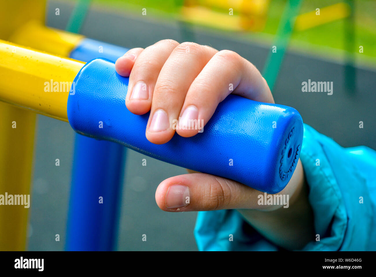 Close up of child hand holding handle of children's sports equipment on ...