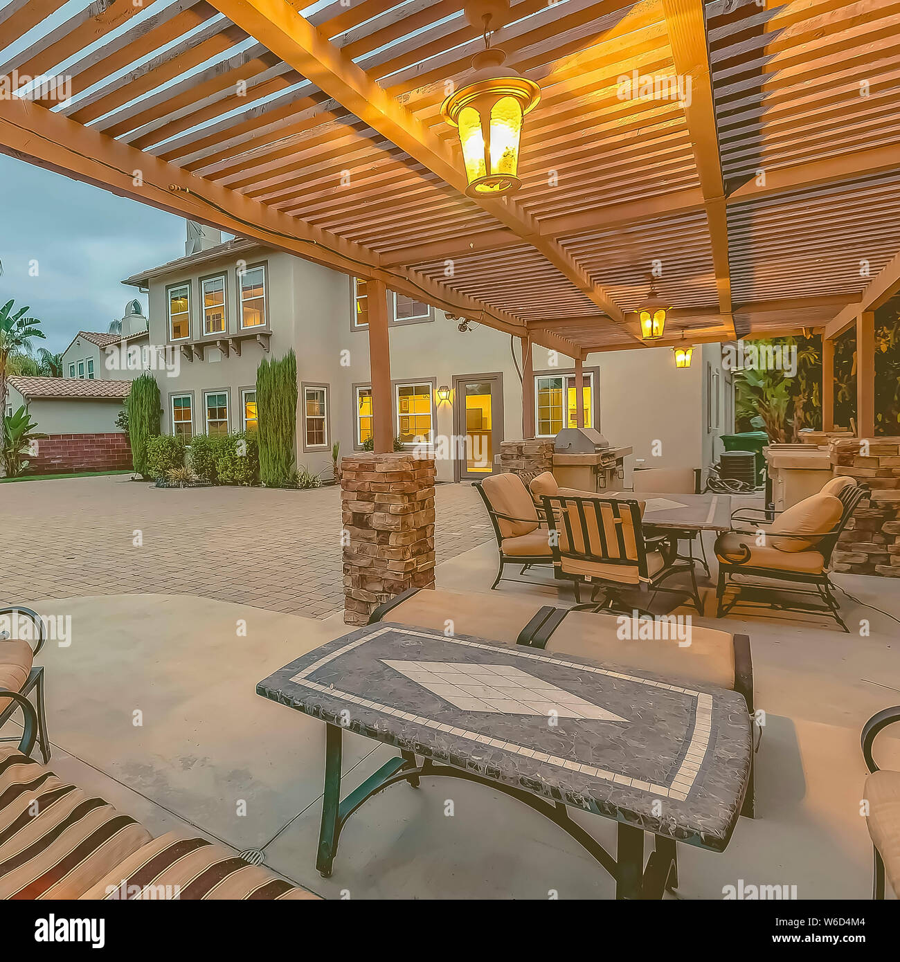 frame Outdoor dining area under a wooden pergola on the patio of a ...