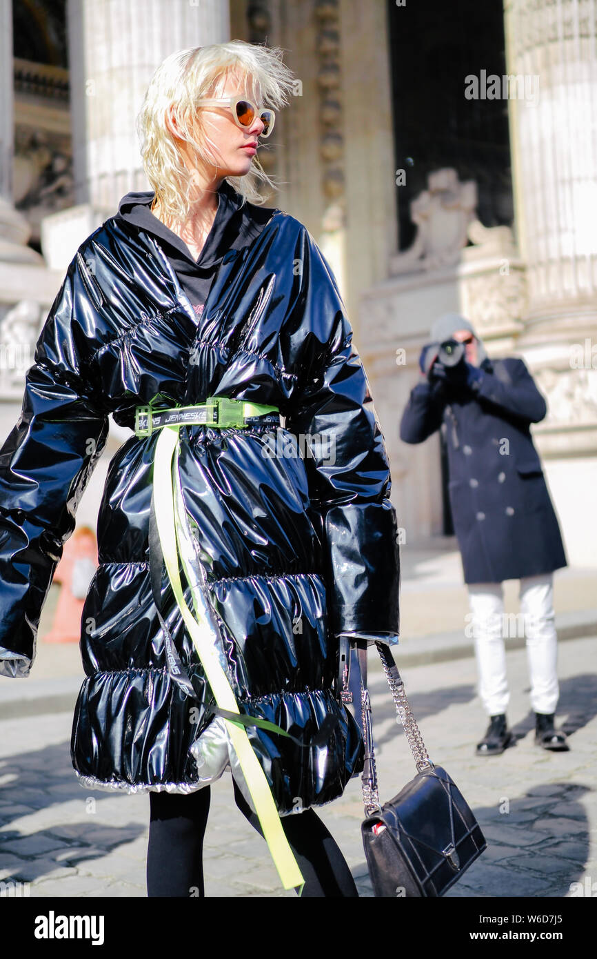A trendy pedestrian walks on the street during the Paris Fashion Week ...