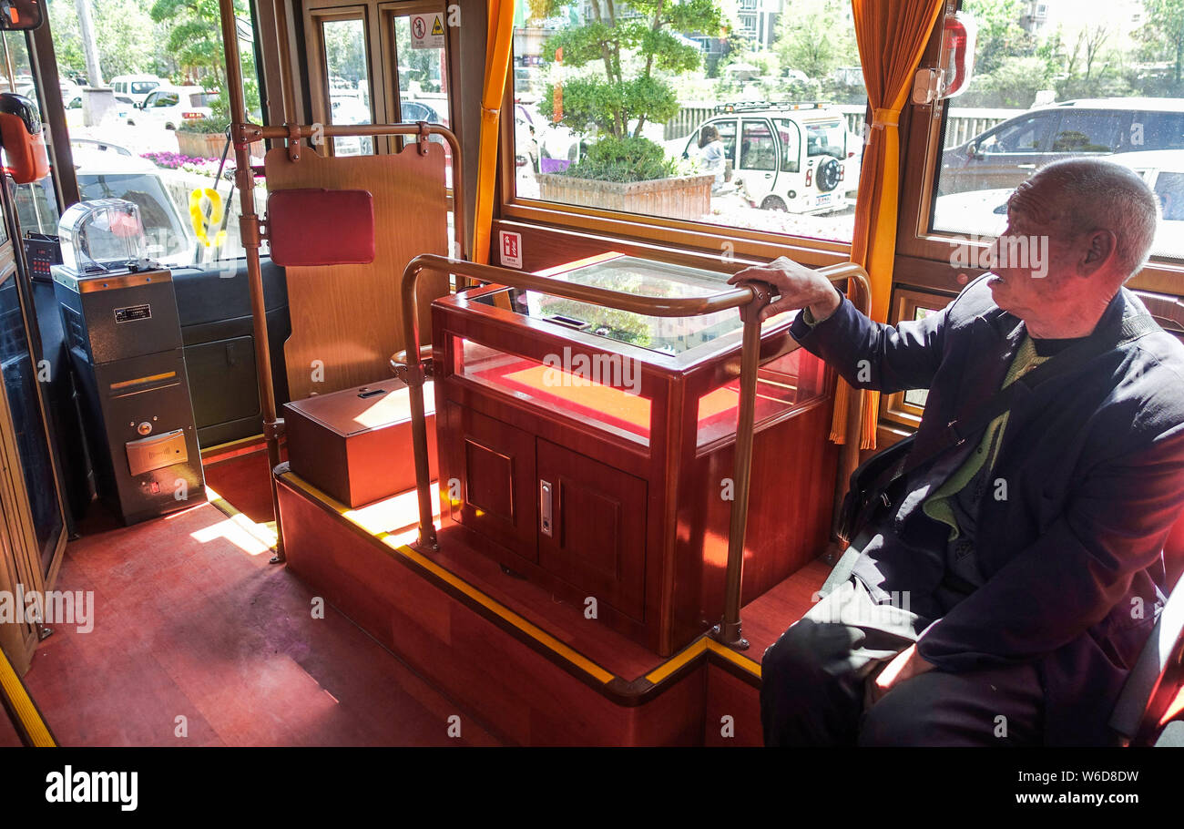 Passengers are seen in a trolley-shaped bus, locally known as a ...