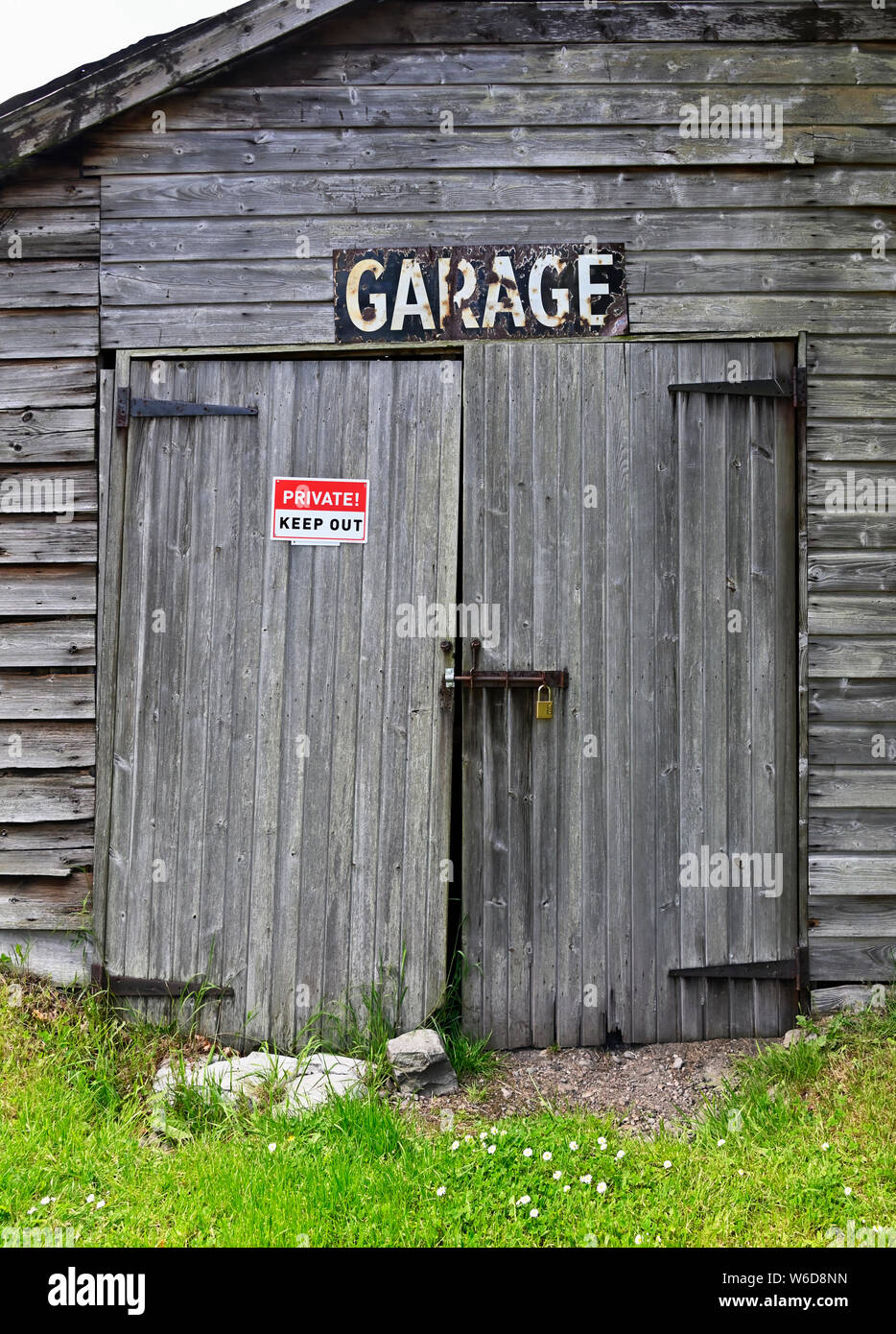 Wooden garage with double doors and "PRIVATE! KEEP OUT" sign. Craig ...