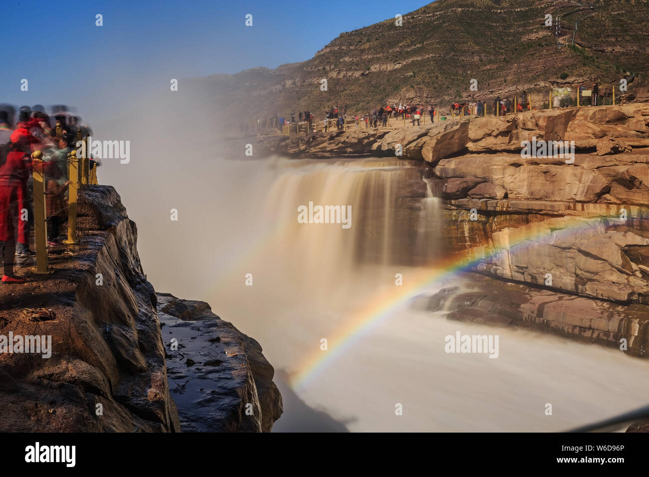 A rainbow arches over the Hukou Waterfall on the Yellow River in Ji ...