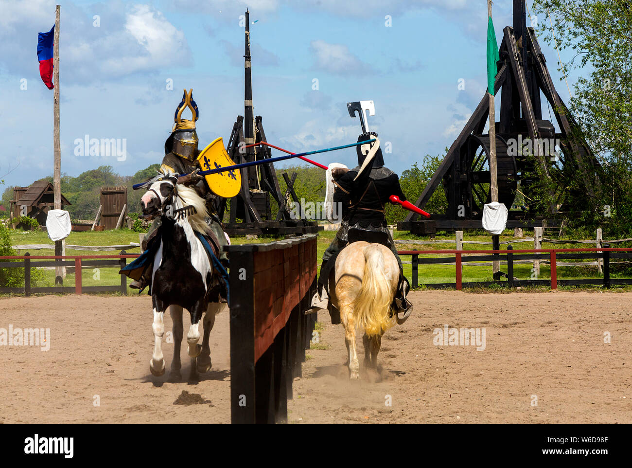 A knight in armour jousting with lance at the outdoor Medieval Centre ...