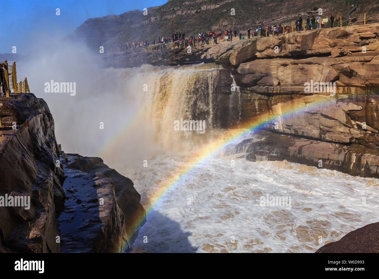 A rainbow arches over the Hukou Waterfall on the Yellow River in Ji ...