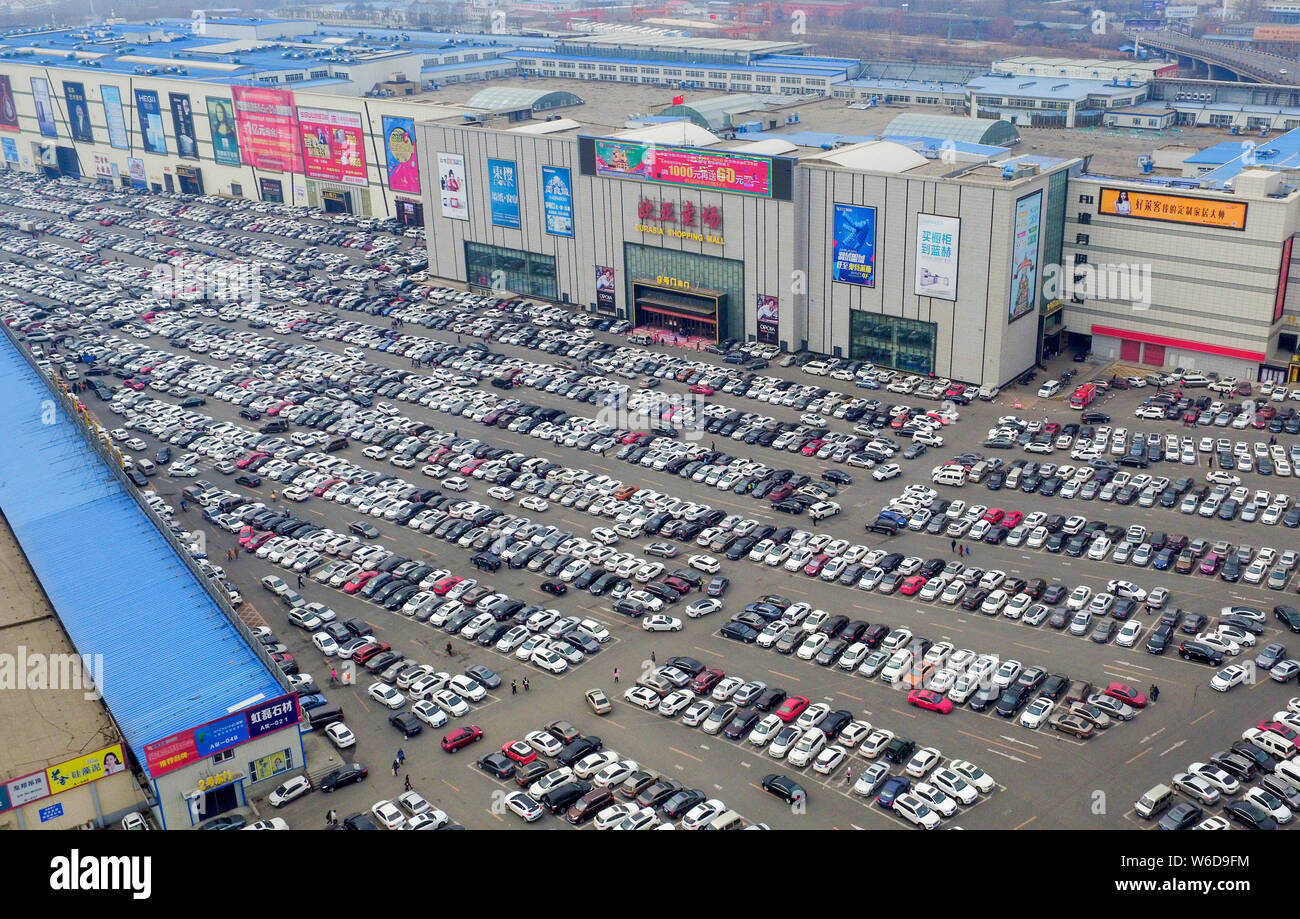 Aerial view of masses of vehicles at a parking lot of a shopping mall ...