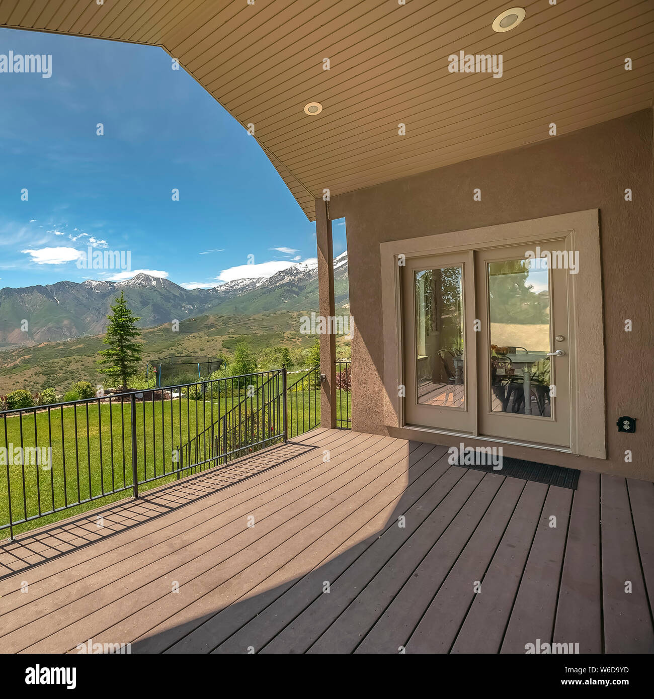 Square frame Home balcony with glass access door and stairs that leads ...