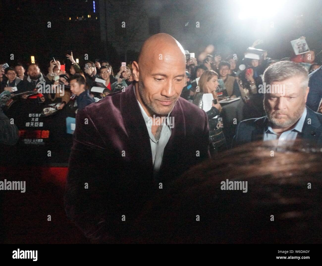 American actor Dwayne Johnson signs autographs for fans as he arrives ...