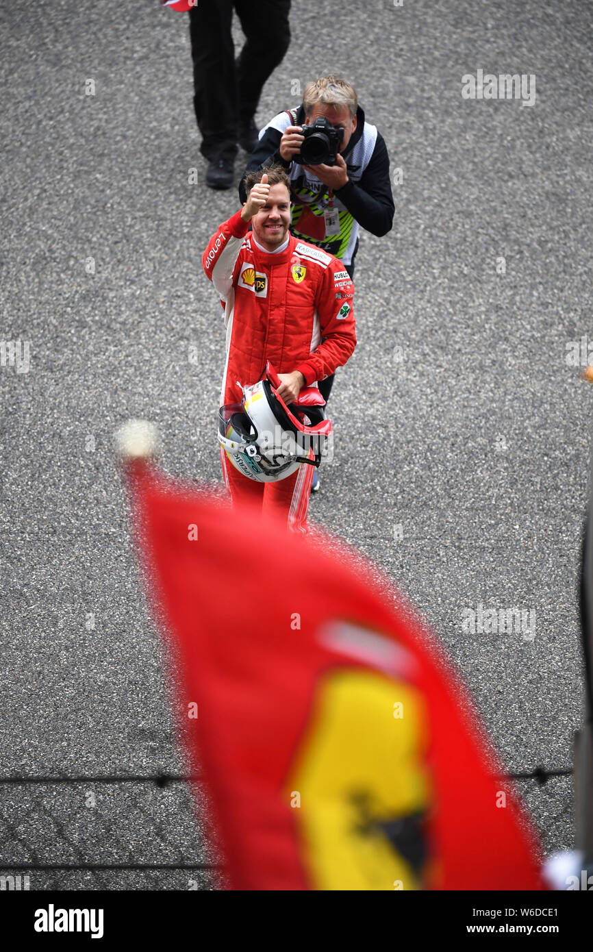 German F1 Sebastian Vettel of Ferrari reacts after winning the pole ...