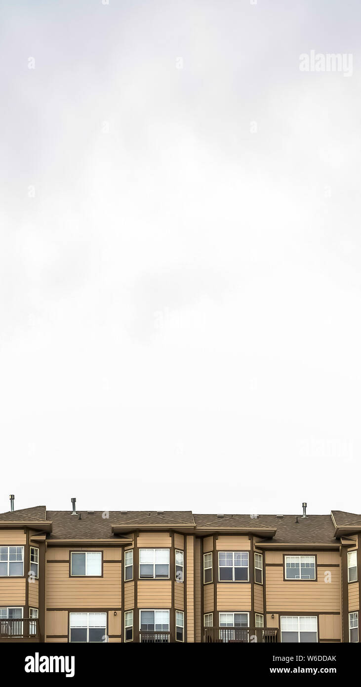 Vertical frame frame Overcast sky over homes with balconies and half ...