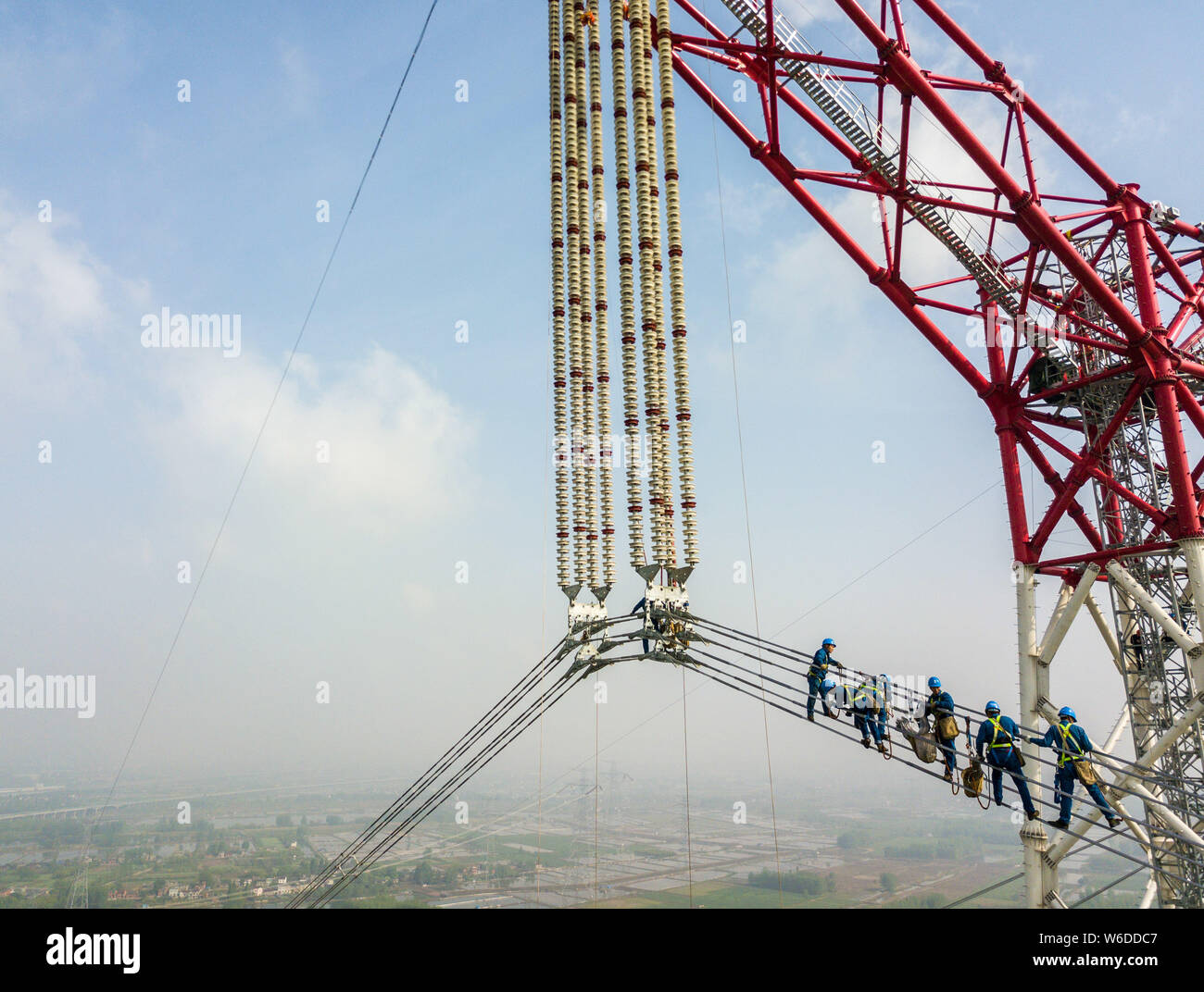 Chinese workers labor at the construction site of the Changji-Guquan ...