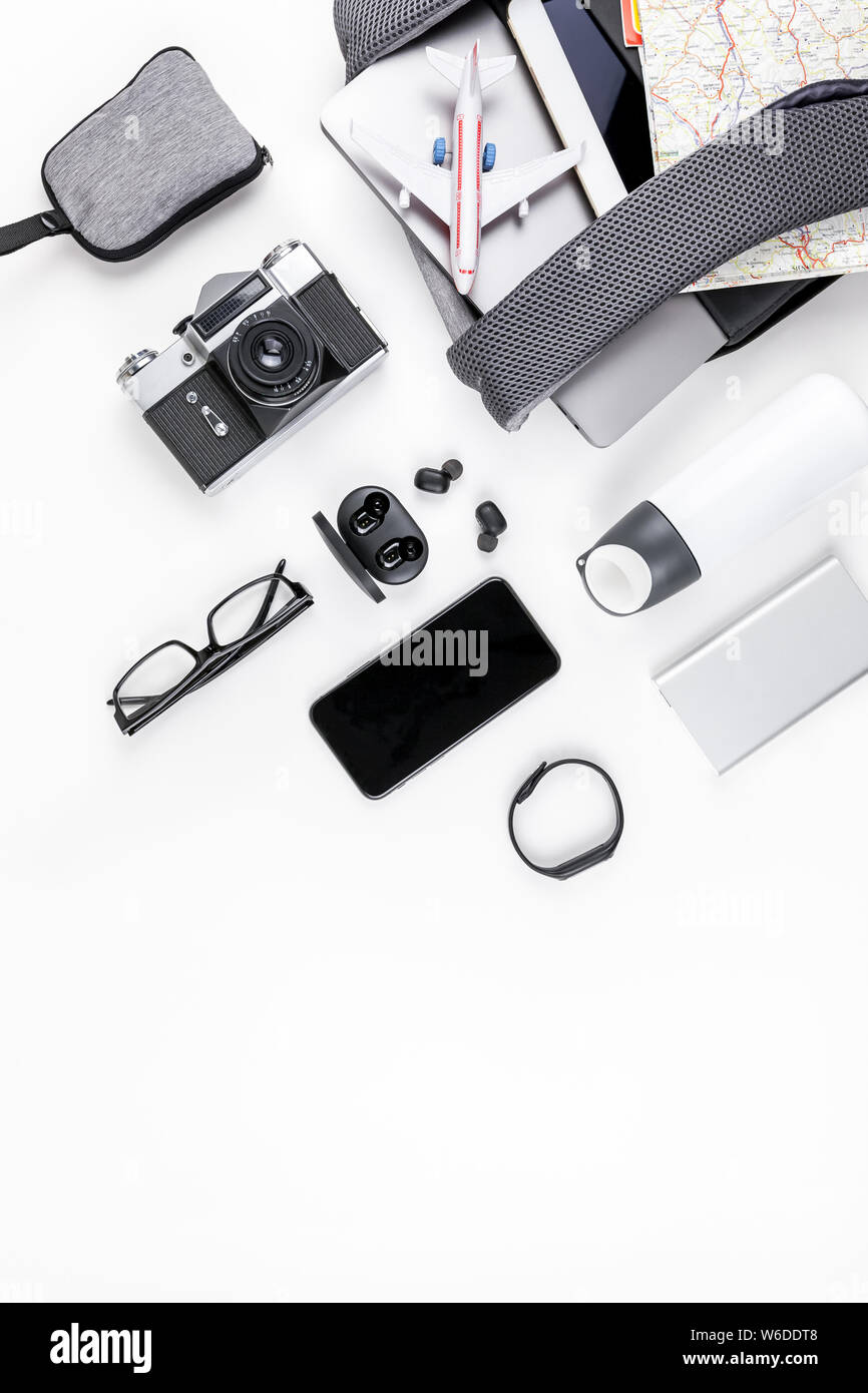 Creative top view flat lay of open backpack with laptop and tablet ...