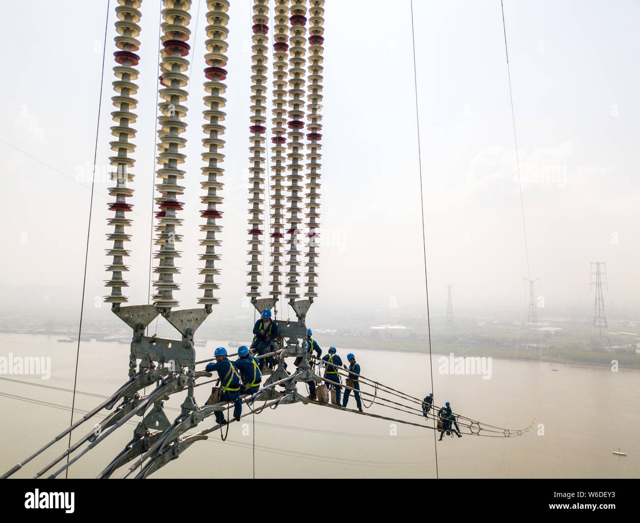 Chinese workers labor at the construction site of the Changji-Guquan ...