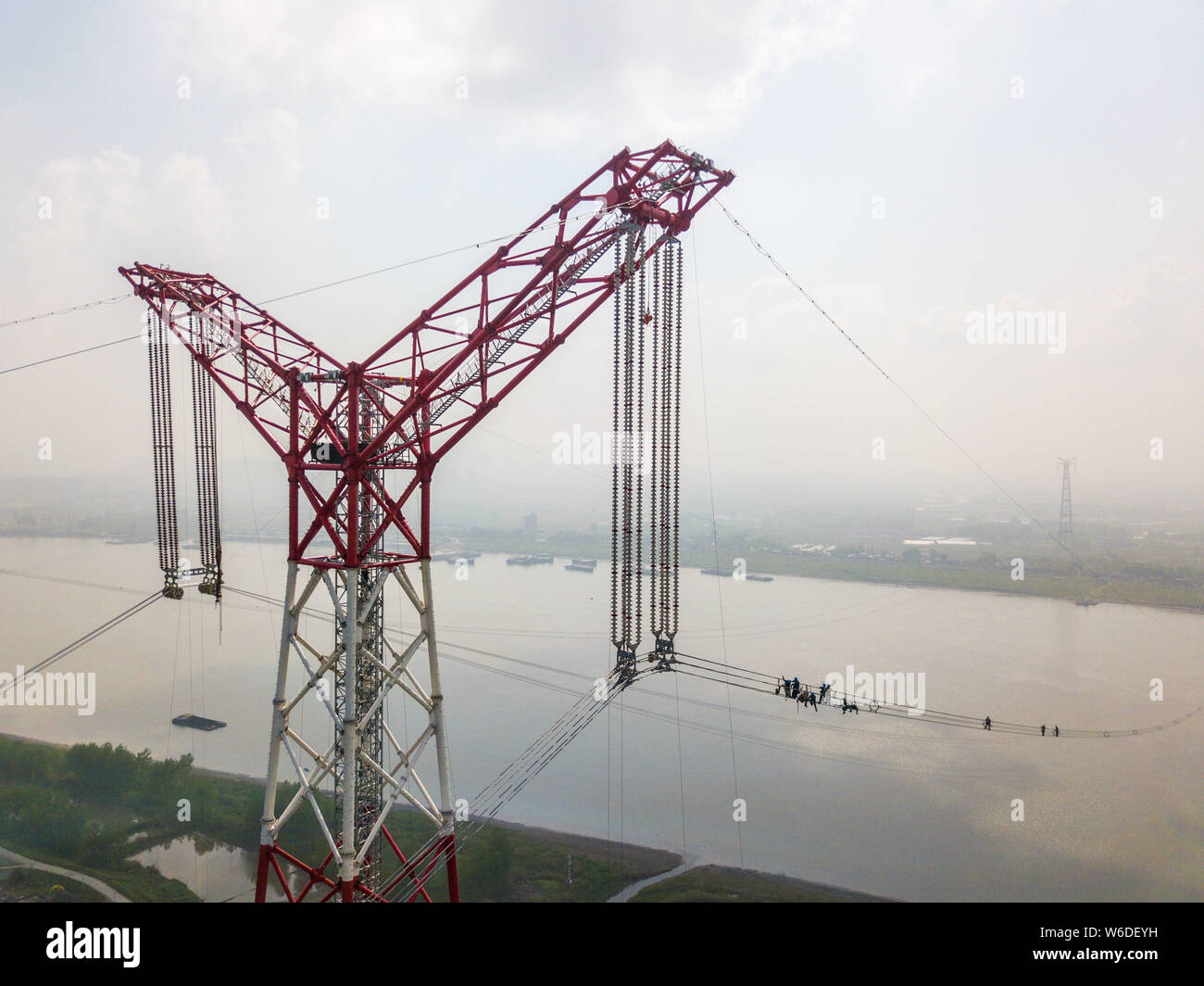 Chinese workers labor at the construction site of the Changji-Guquan ...